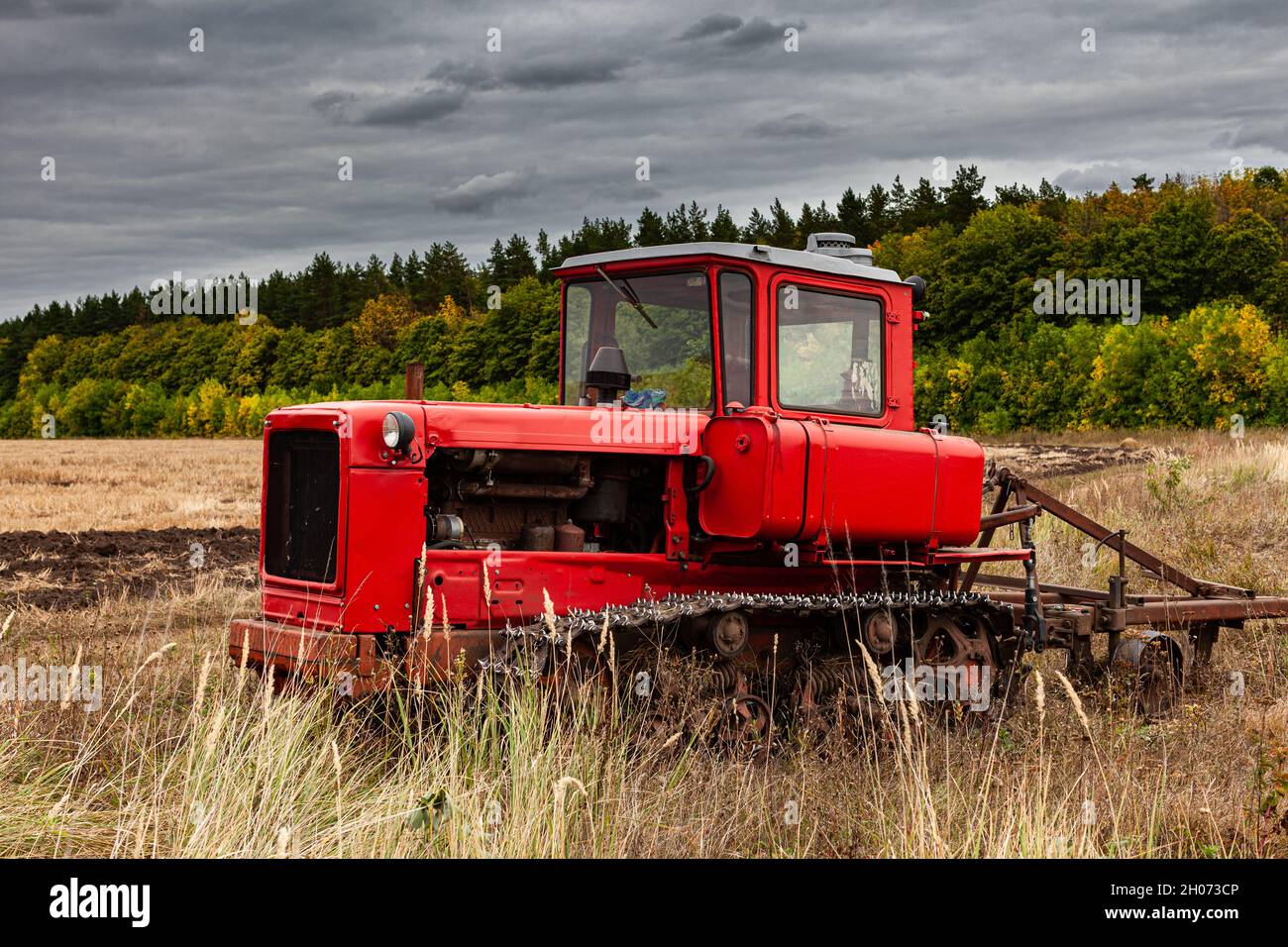 crawler tractor standing in a field on arable land Stock Photo - Alamy