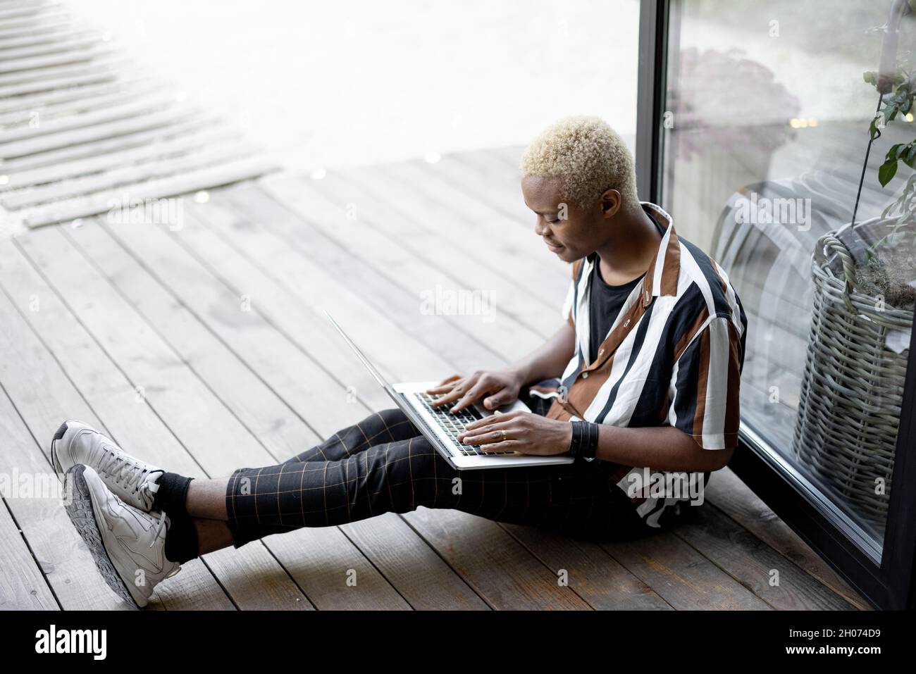 Black man laptop computer outside patio hi-res stock photography and ...