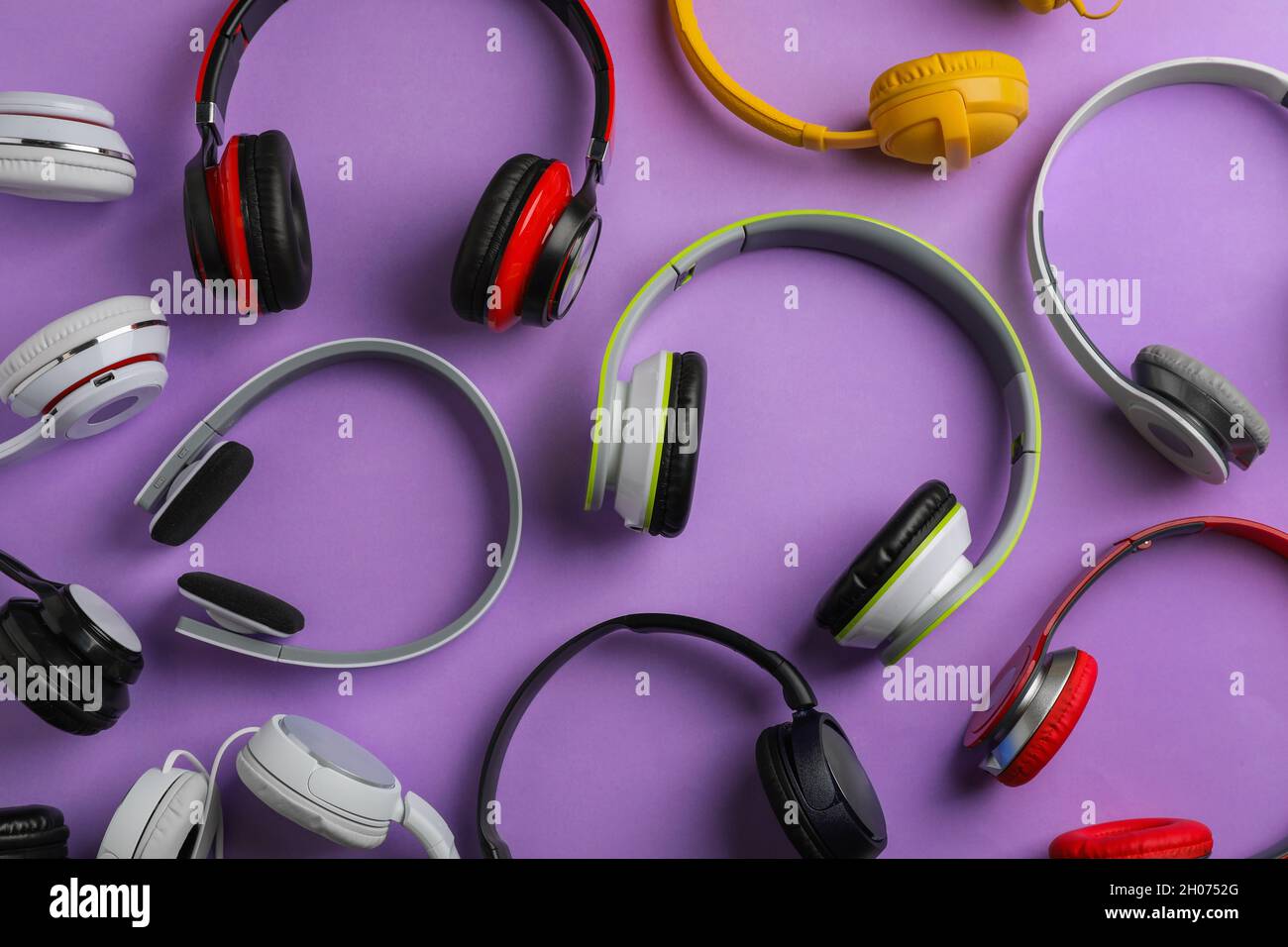 Many different headphones on color background, top view Stock Photo - Alamy