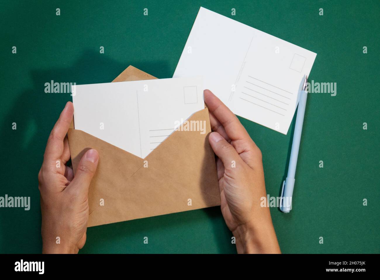 envelope with Christmas letter postcard on green background Stock Photo ...