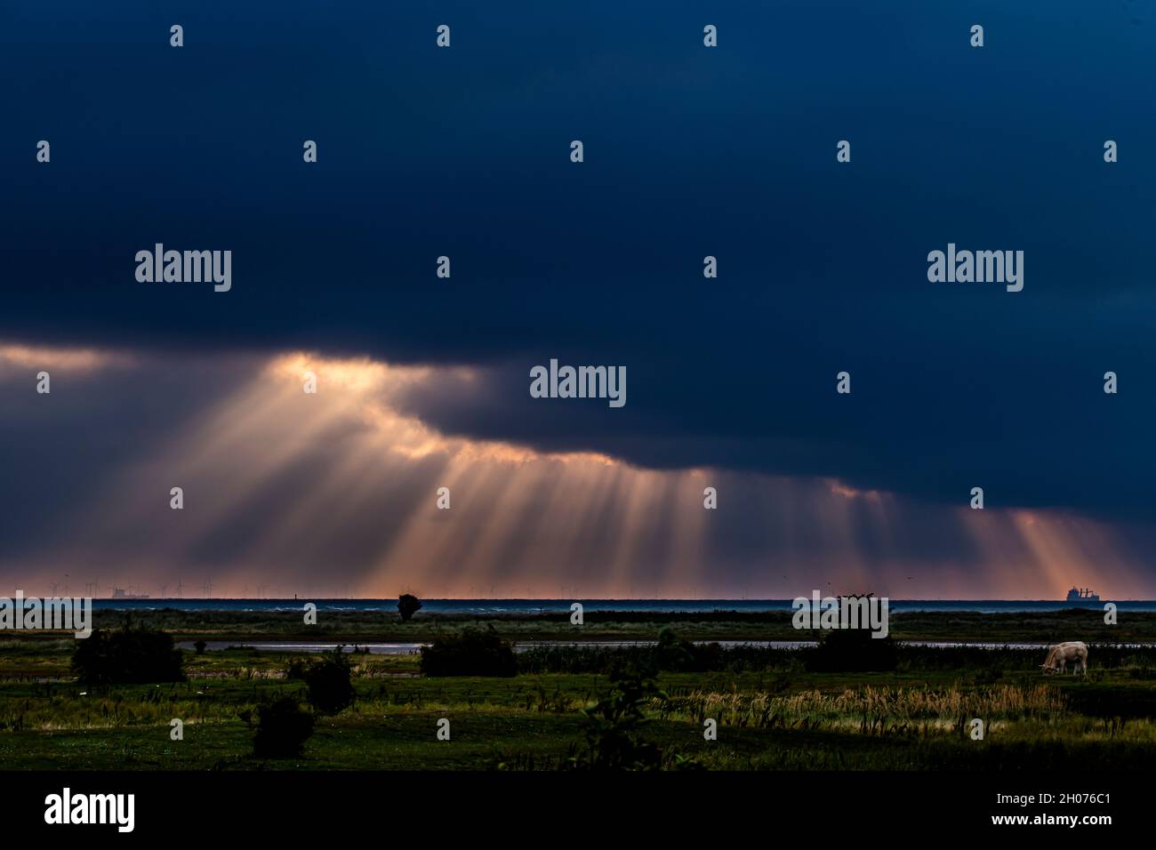 dramatic cloudy sky releases sun beams Stock Photo - Alamy
