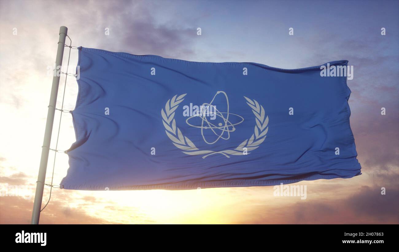 Flag of International Atomic Energy Agency IAEA waving in the wind, sky ...