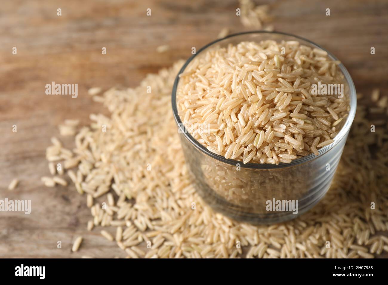 Brown rice in glass on table. Space for text Stock Photo - Alamy