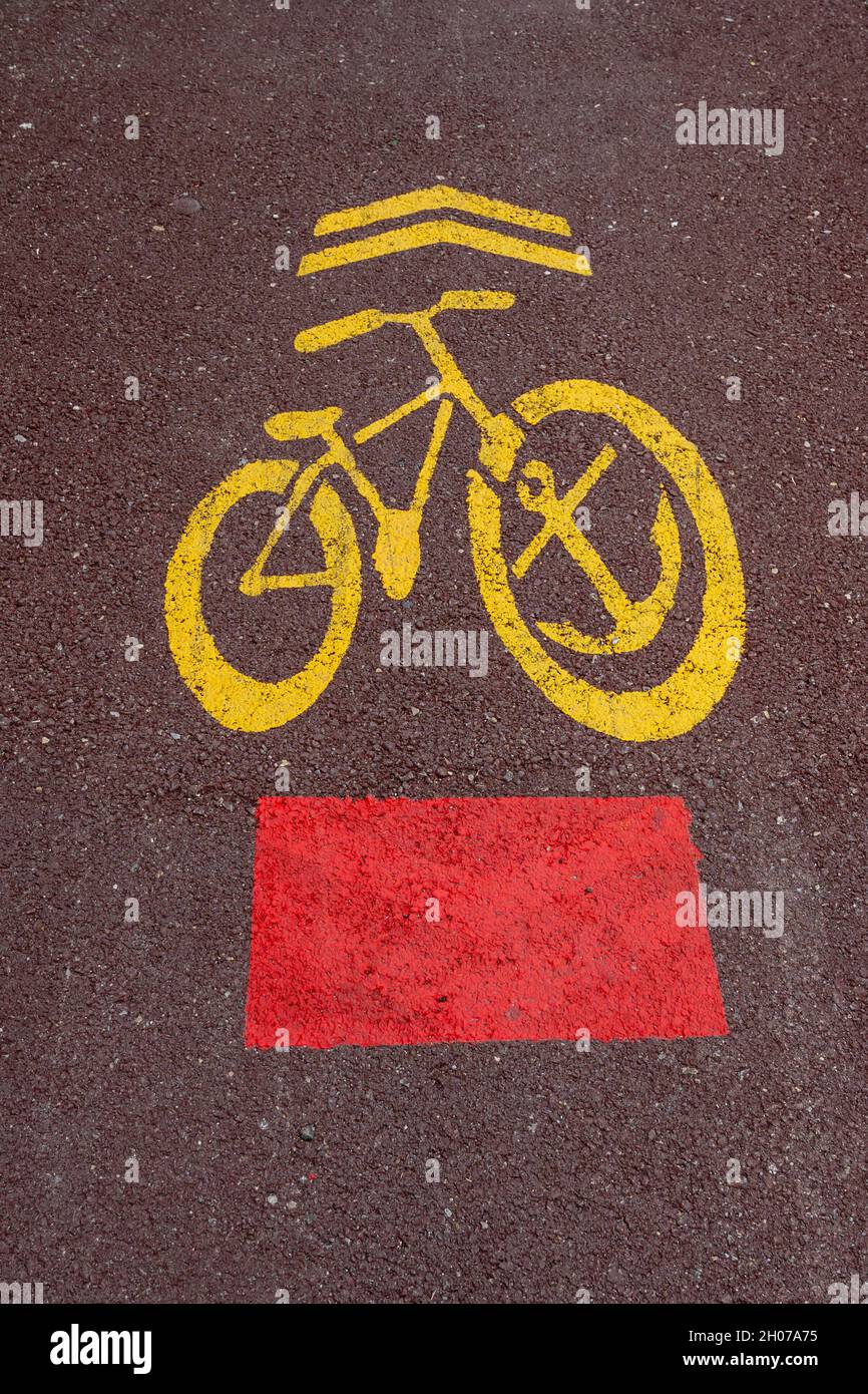Bike lanes yellow sign anchor red background Stock Photo - Alamy