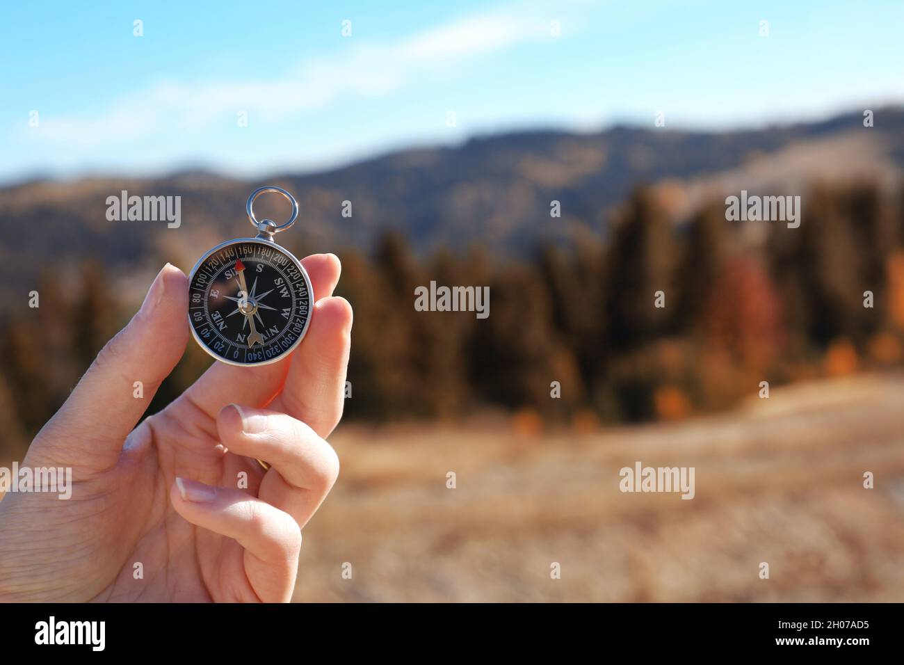Traveler searching direction with compass in wilderness, closeup. Space ...