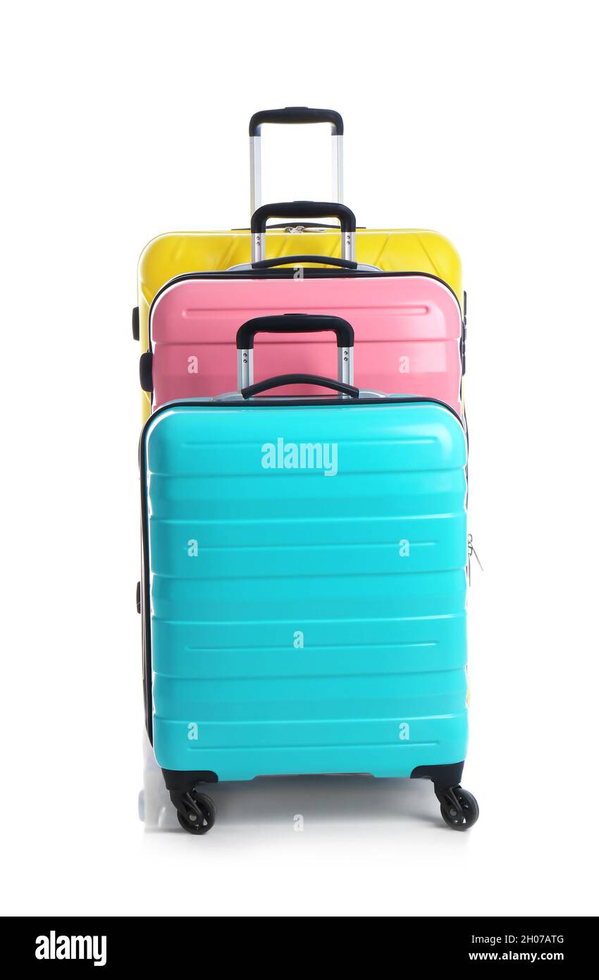 Modern suitcases for travelling on white background Stock Photo - Alamy