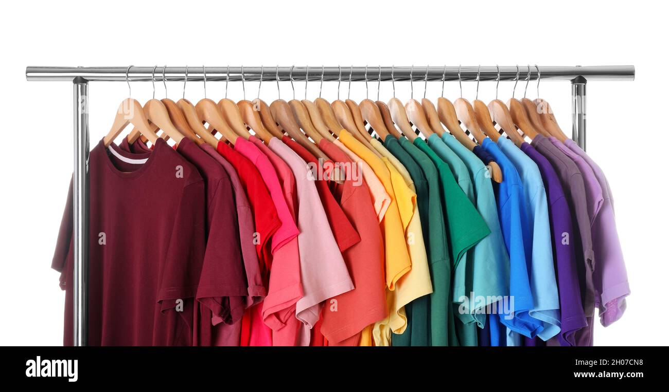 Rack with rainbow clothes on light background Stock Photo - Alamy