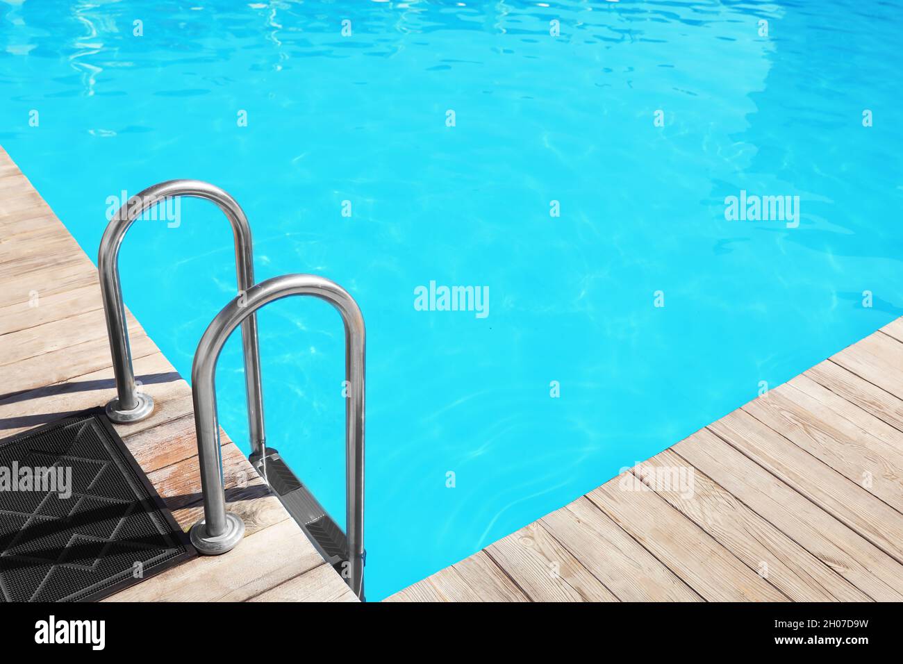 Modern swimming pool with step ladder outdoors Stock Photo - Alamy