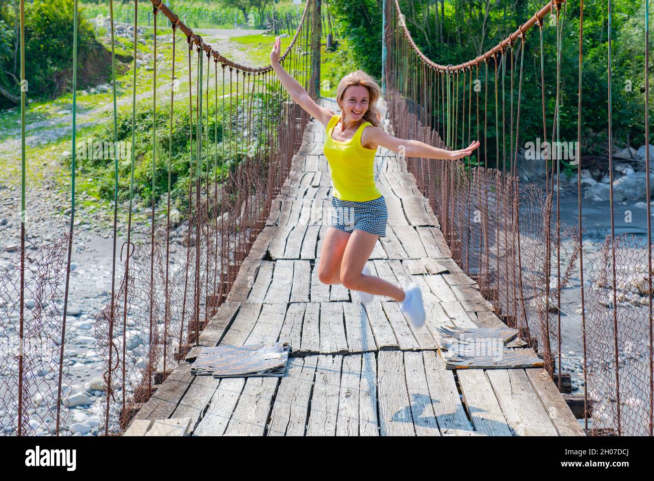 one person jumping on a suspension bridge in Georgia Stock Photo - Alamy