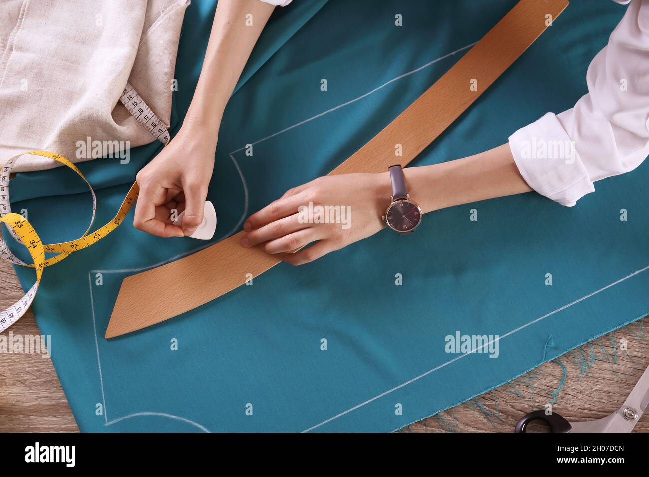 Tailor working with cloth at table in atelier, top view Stock Photo - Alamy