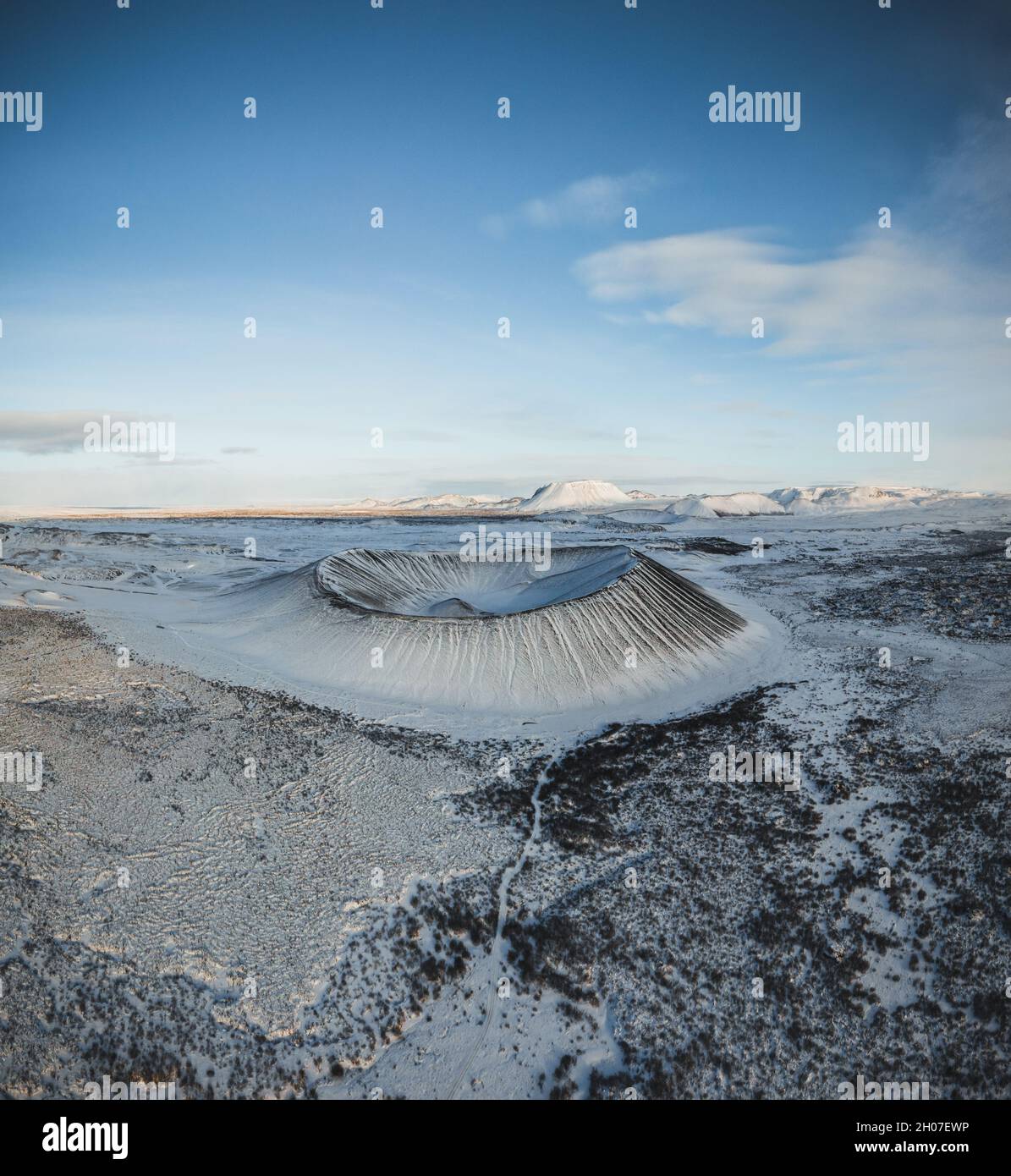 Aerial drone panorama snowy winter landscape view of huge volcano cone ...