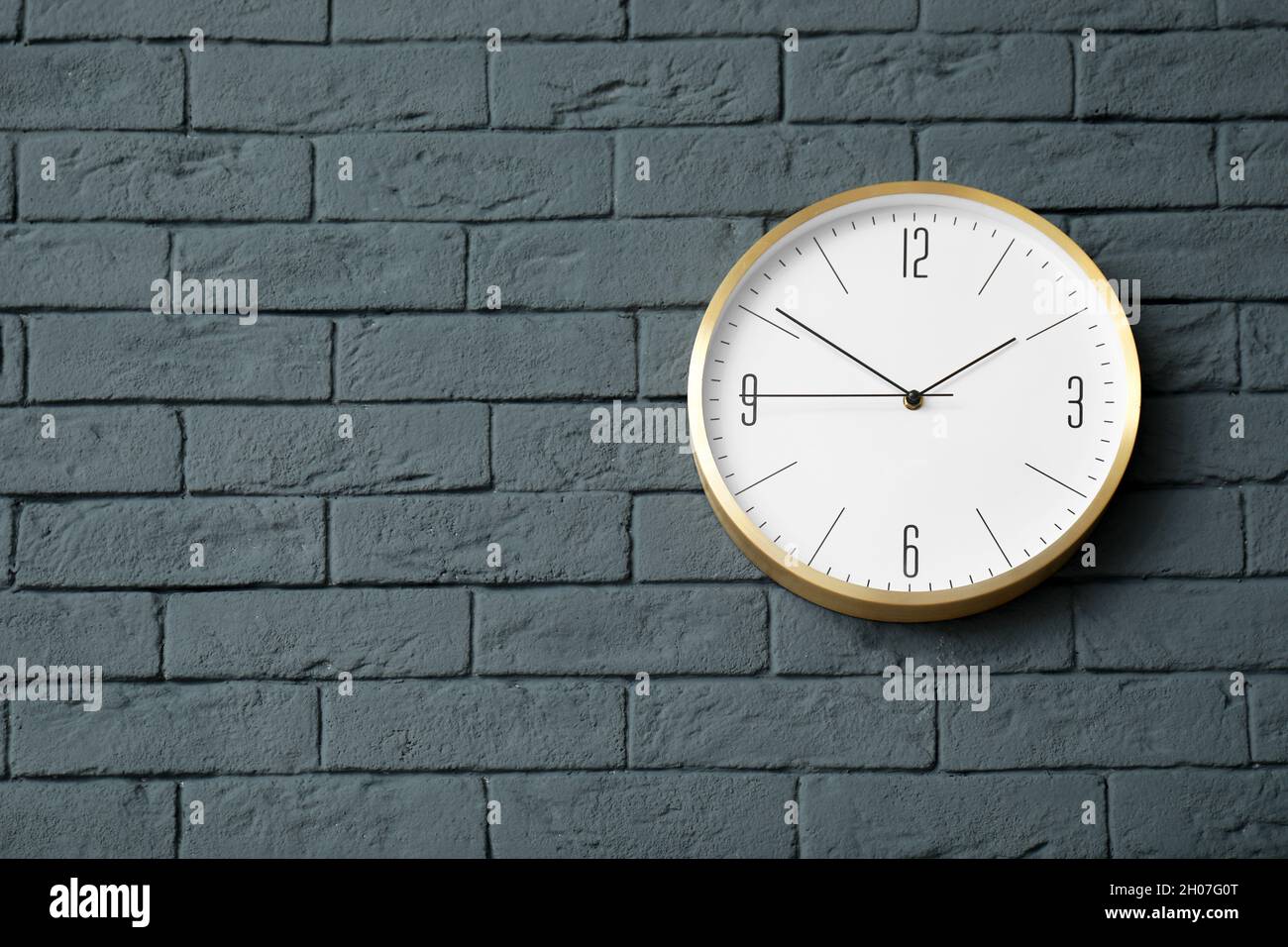 Modern clock on brick wall. Time concept Stock Photo - Alamy