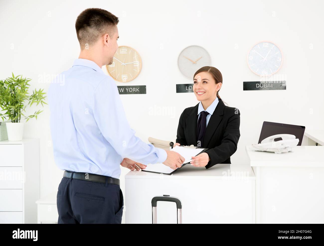 Woman filling form reception desk hi-res stock photography and images ...