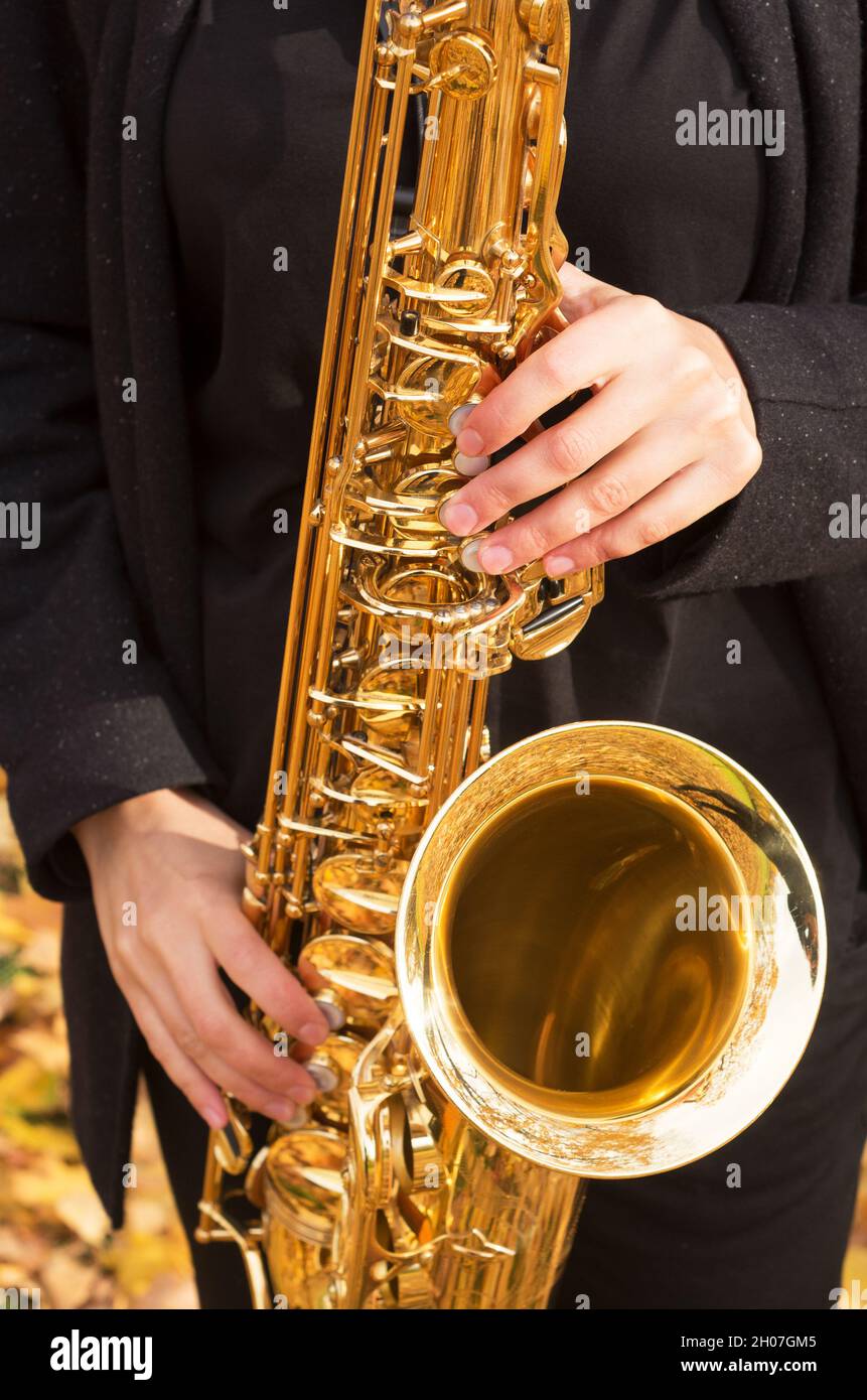 Girl musician plays saxophone hi-res stock photography and images - Alamy