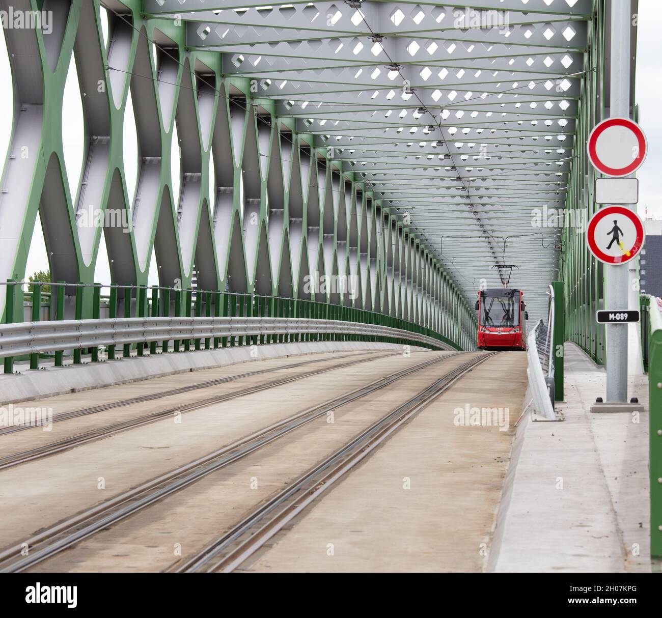 Modern tram driving on railway on steel constructed bridge Stock Photo ...