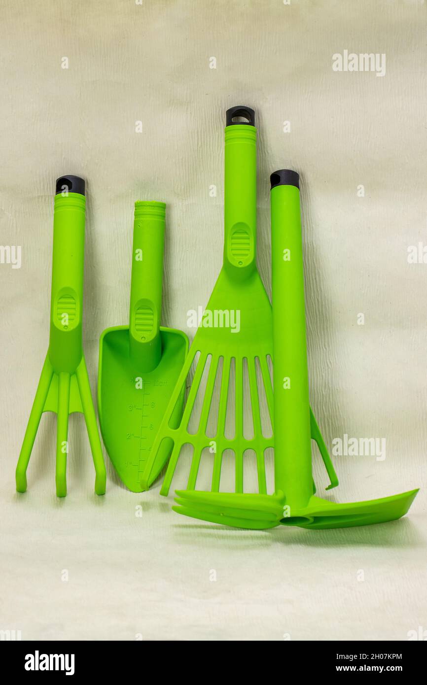 Green Plastic Garden Tools including a trowel, rake, fork Stock Photo ...