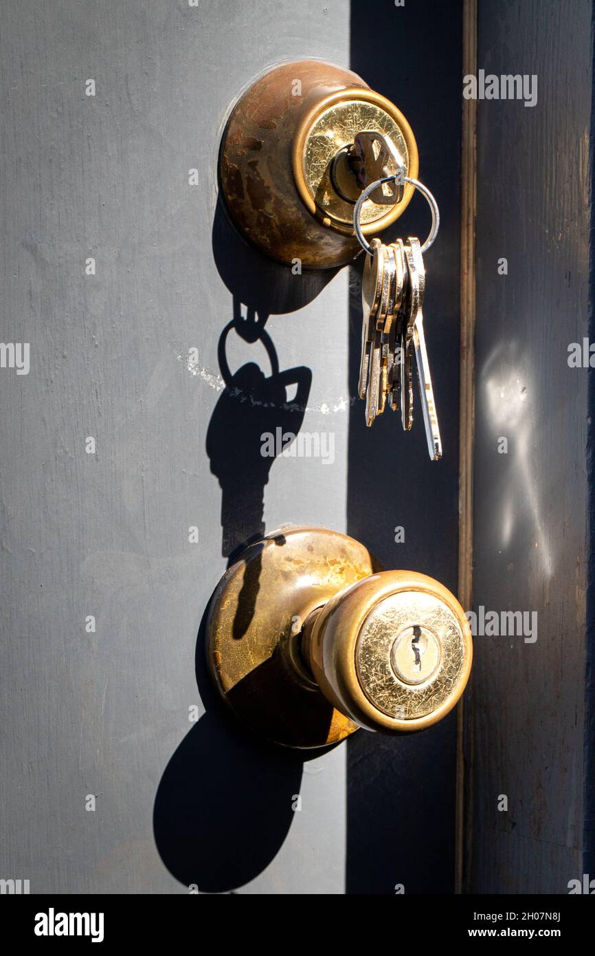 Keys Hanging From A Deadbolt Lock Stock Photo - Alamy