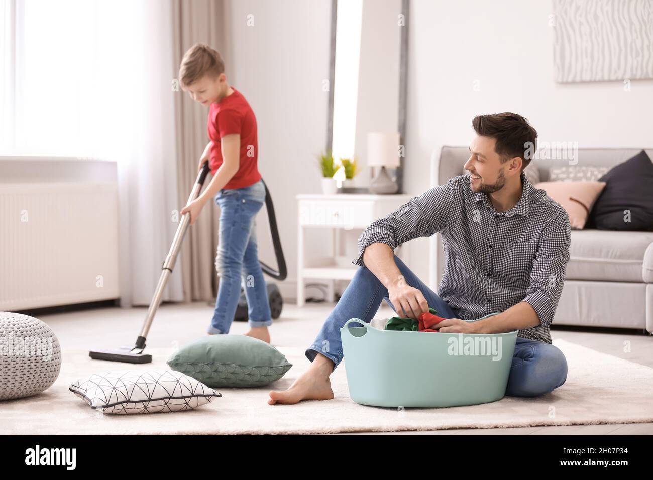 Little boy and his dad cleaning their house together Stock Photo - Alamy