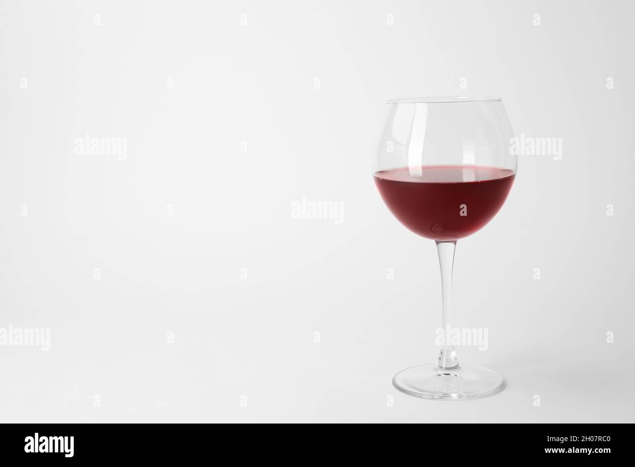 Glass of expensive red wine on light background Stock Photo - Alamy