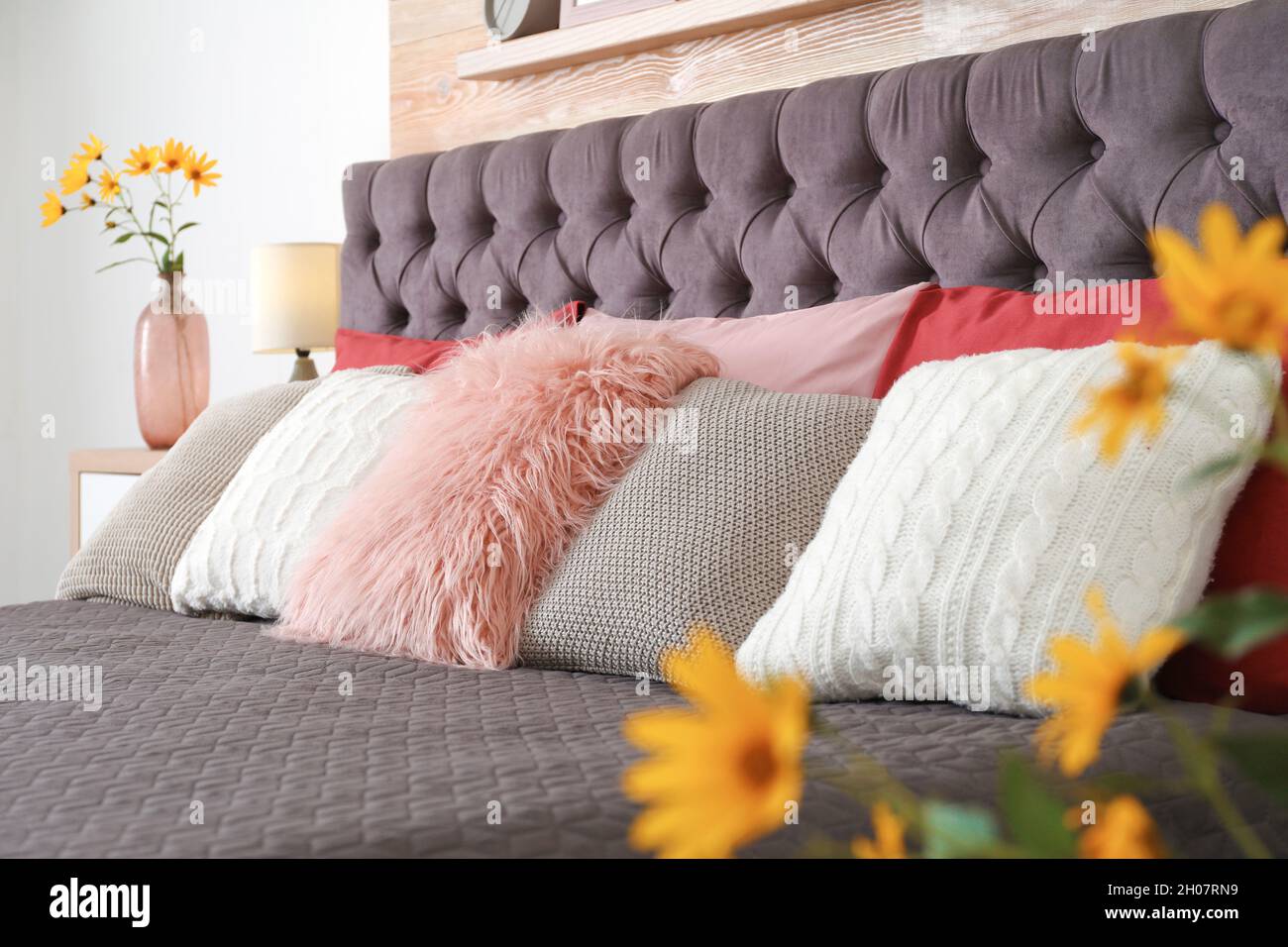 Different pillows on bed in room. Idea for interior decor Stock Photo ...