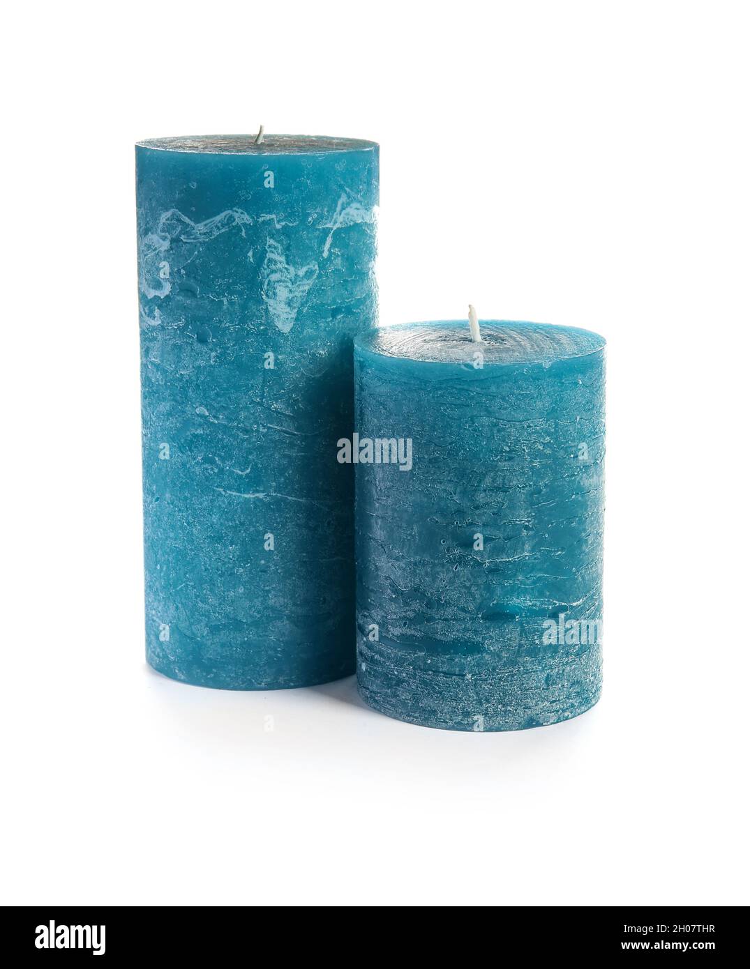 Two decorative blue wax candles on white background Stock Photo - Alamy