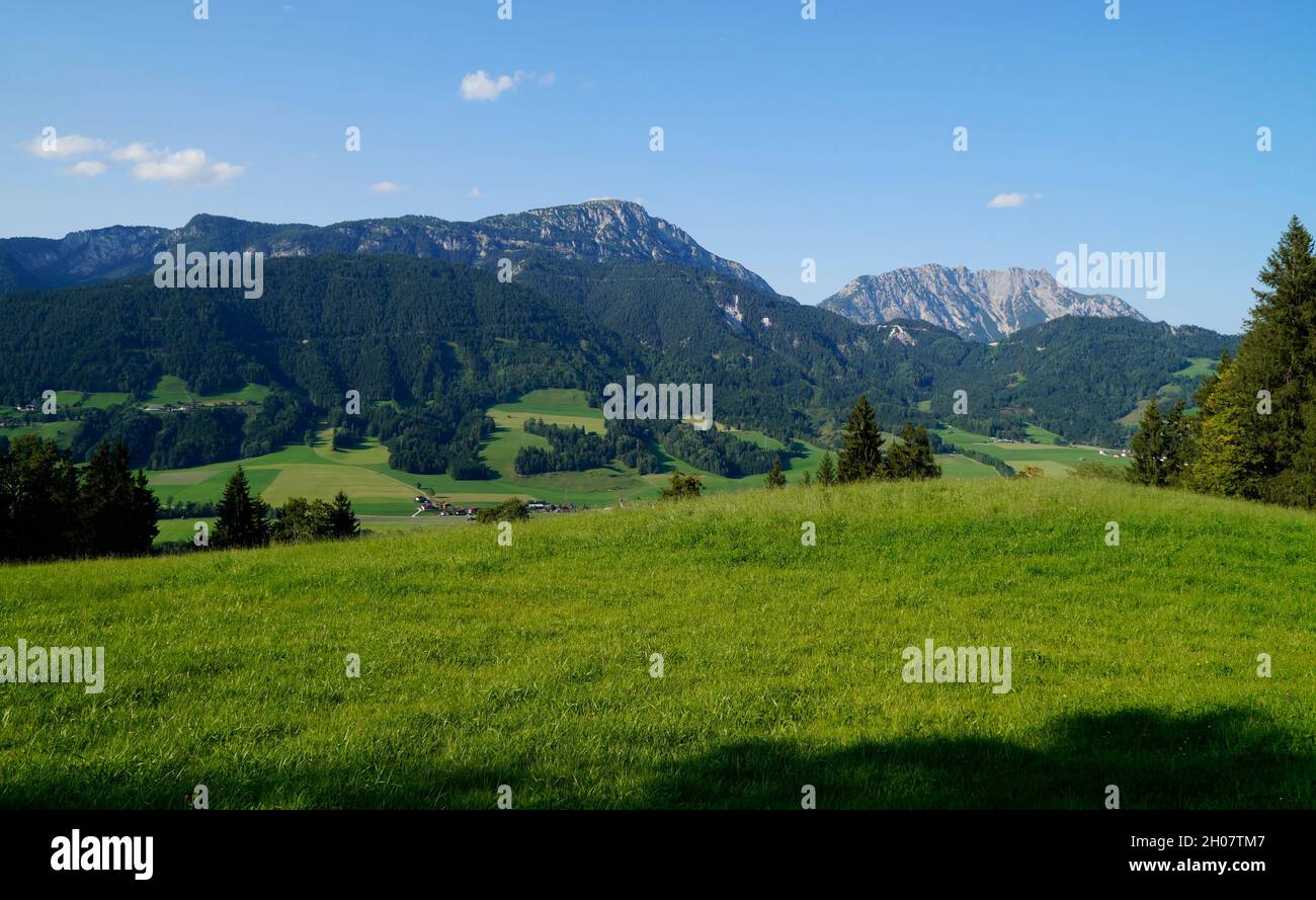 a scenic view of a country house and the green meadows in the Austrian ...