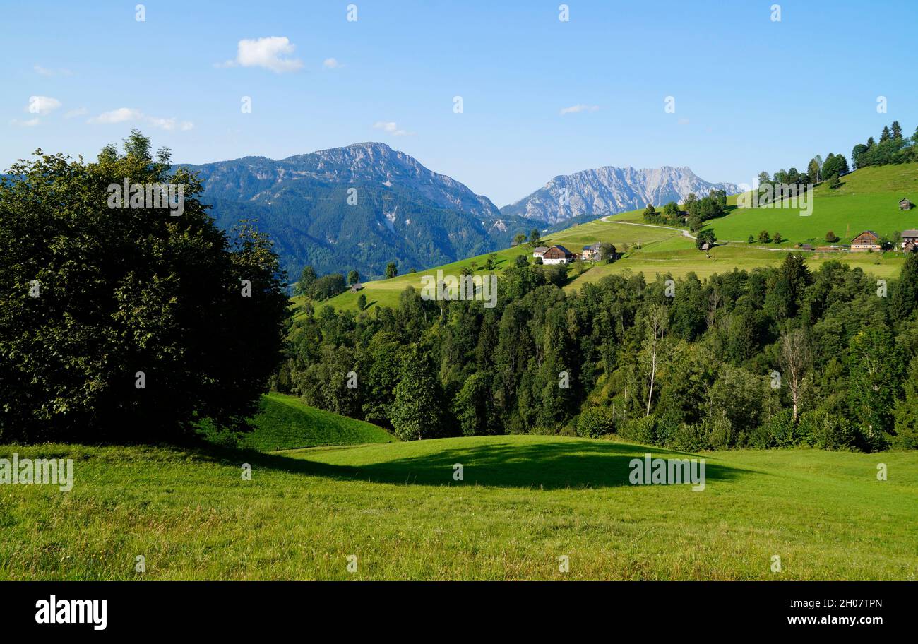 a scenic view of a country house and the green meadows in the Austrian ...