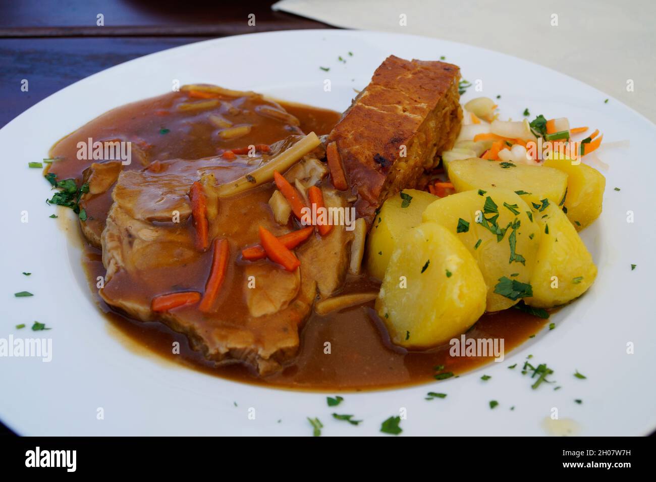 delicious austrian dish consisting of a pork roast, potatoes and a ...