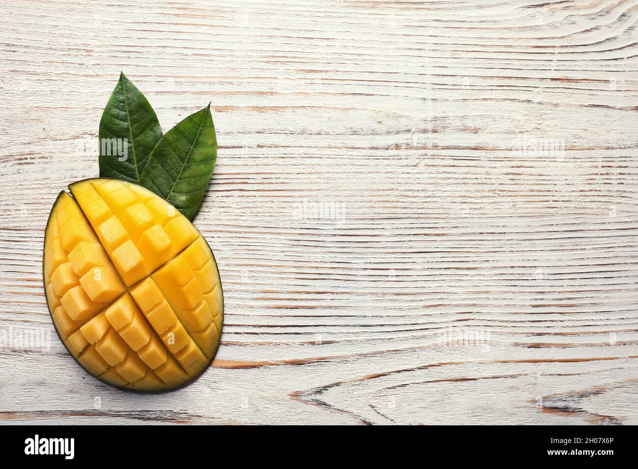 Flat lay composition with mango on white wooden background. Space for ...