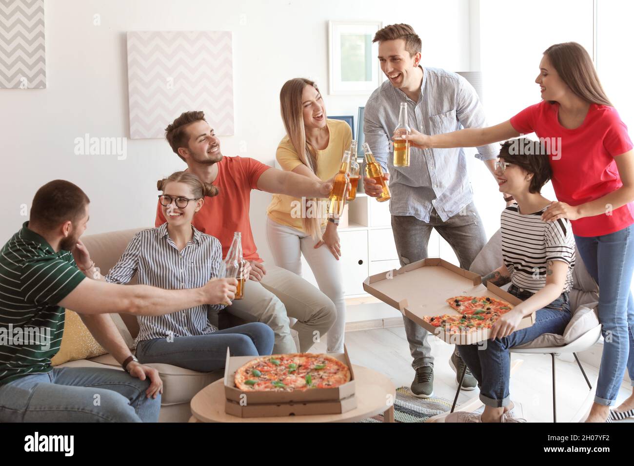 Young people having fun party with delicious pizza indoors Stock Photo ...