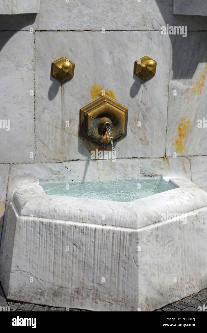 White marble stone drinking water fountain with brass Stock Photo - Alamy