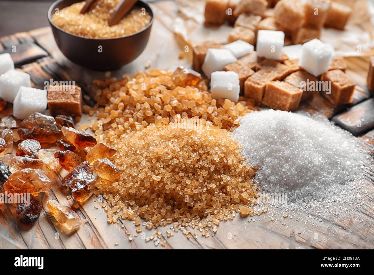 Different types of sugar on wooden table Stock Photo - Alamy