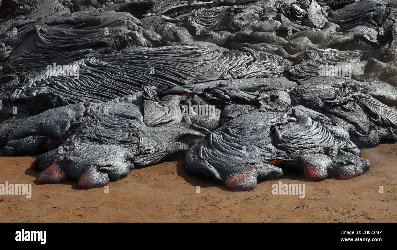 Pahoehoe lava flow at Fagradalsfjall, Iceland. Lava crust is gray and ...