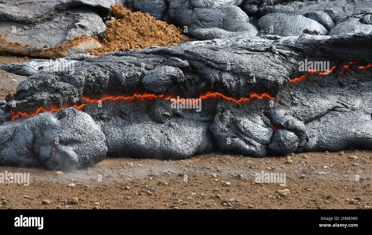 Pahoehoe lava flow at Fagradalsfjall, Iceland. Lava crust is gray and ...