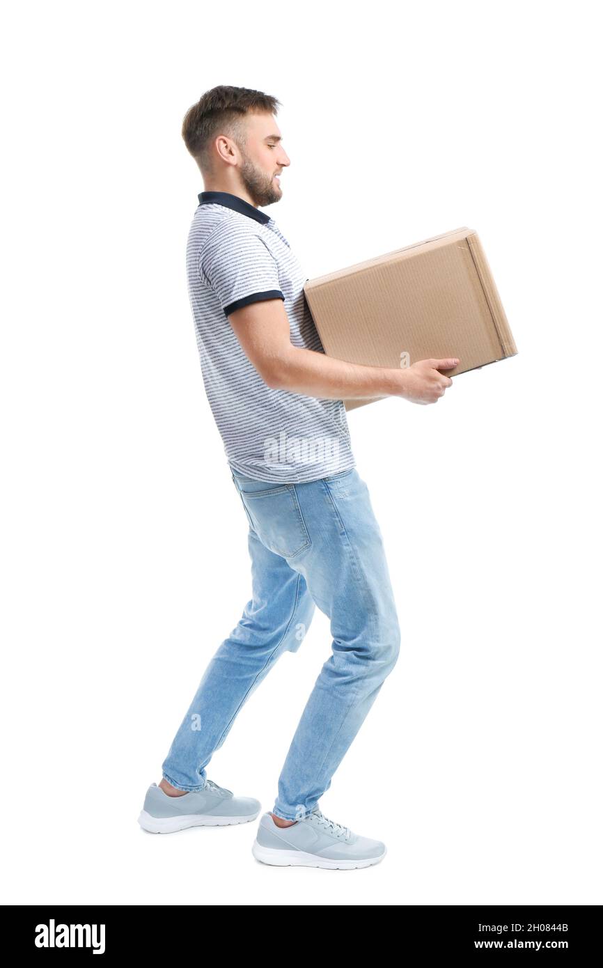 Full length portrait of young man carrying carton box on white ...