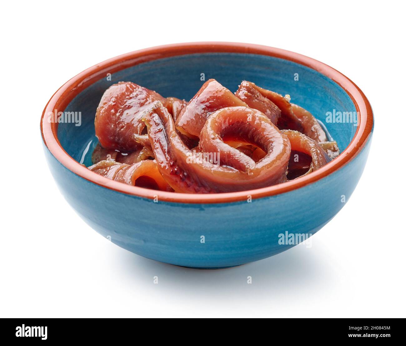 bowl of canned anchovy fillets isolated on white background Stock Photo ...