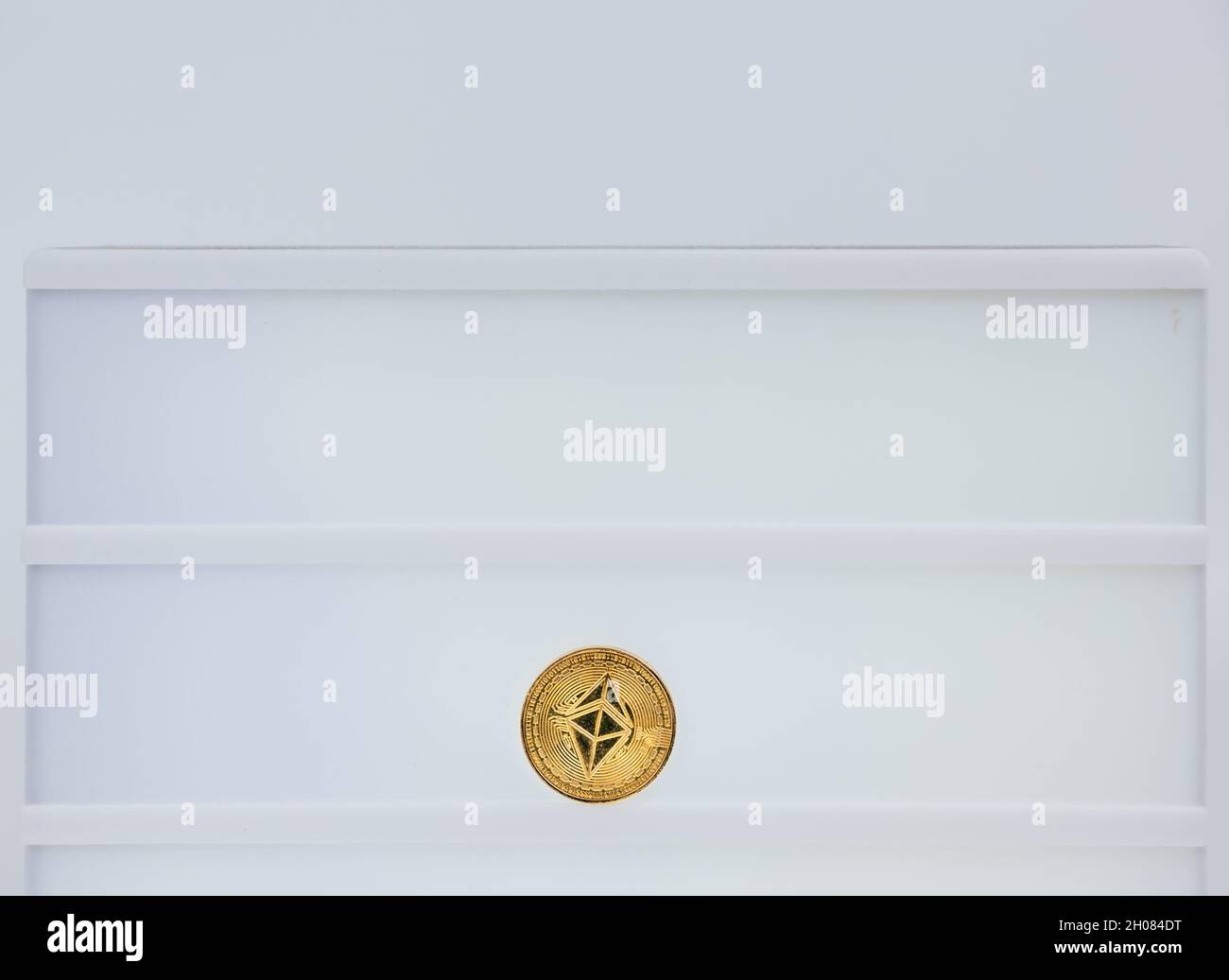 Gold ETH coin on a white background Stock Photo - Alamy