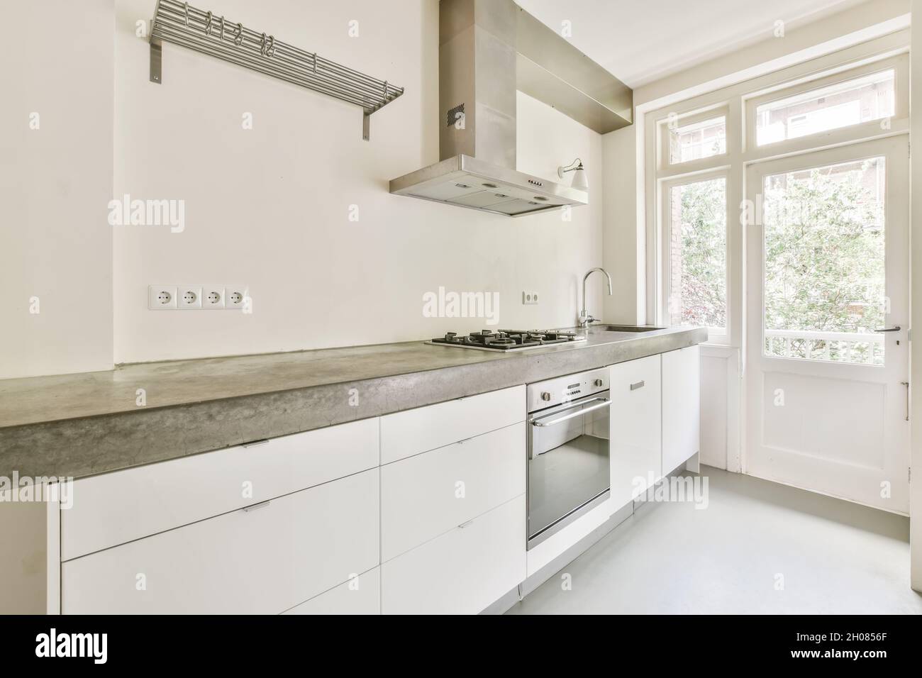 Beautiful renovated empty kitchen interior with a modern silver design ...