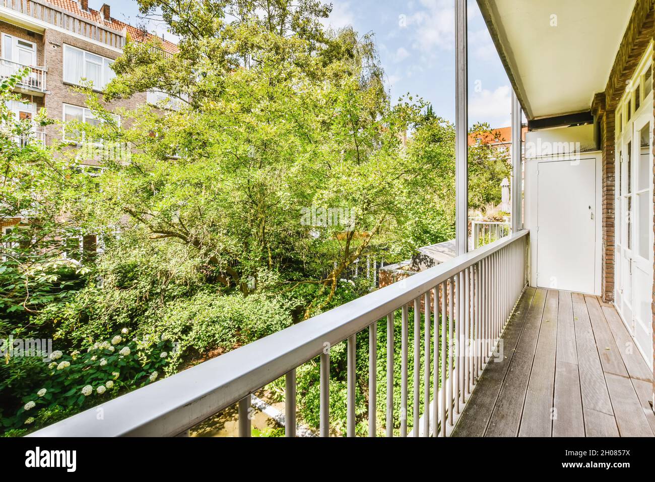 Beautiful house balcony with a view of a blooming park Stock Photo - Alamy