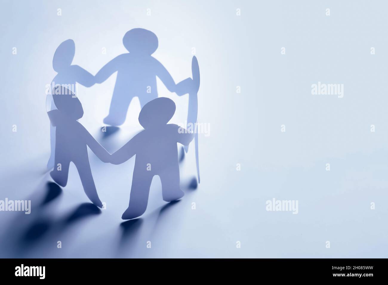 Paper people holding hands on light background. Unity concept Stock ...