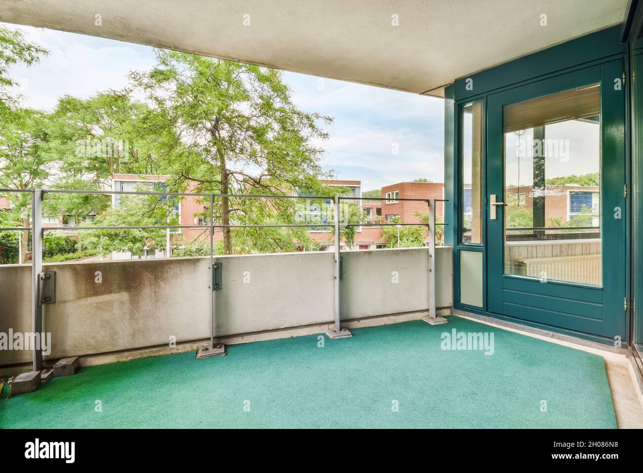 Beautiful shot of an empty balcony with a large green door Stock Photo ...