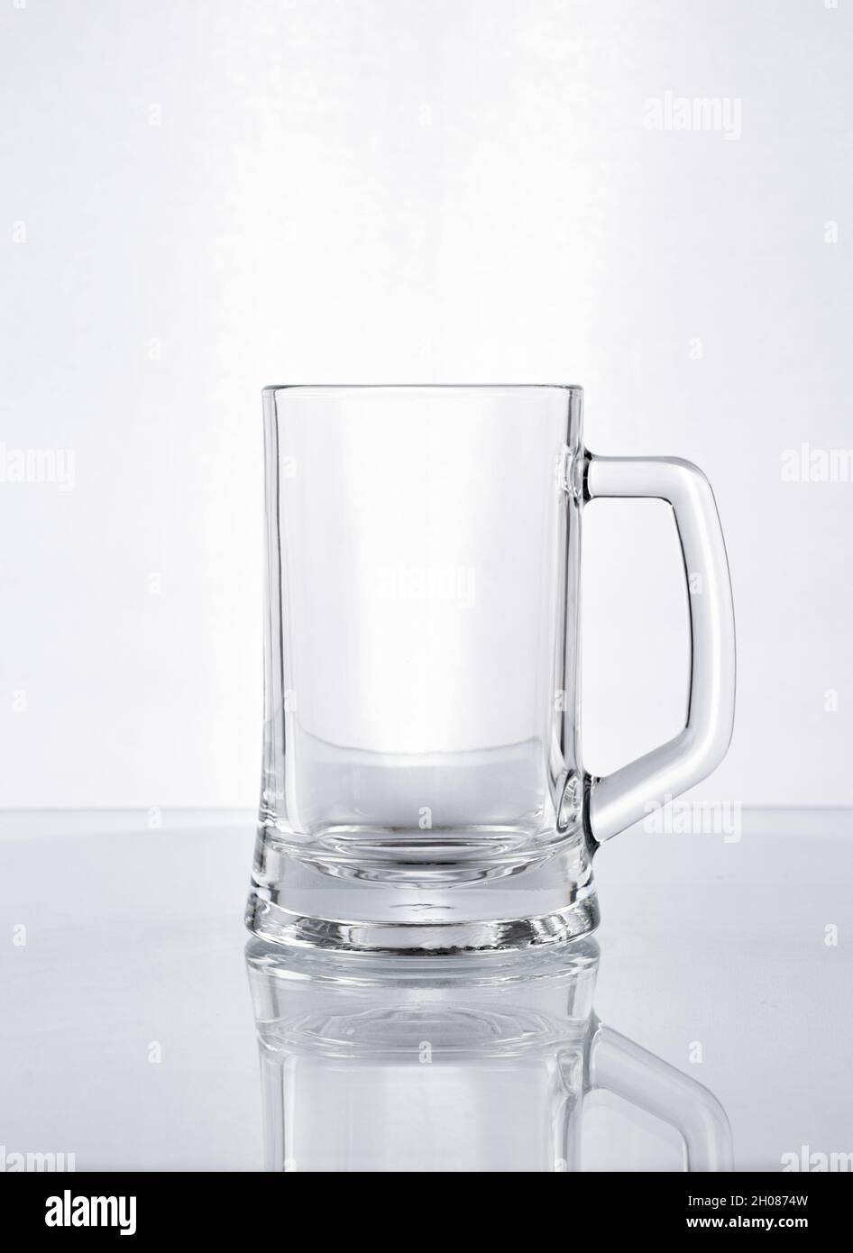 Shaped glass jug for beer on a white background Stock Photo - Alamy