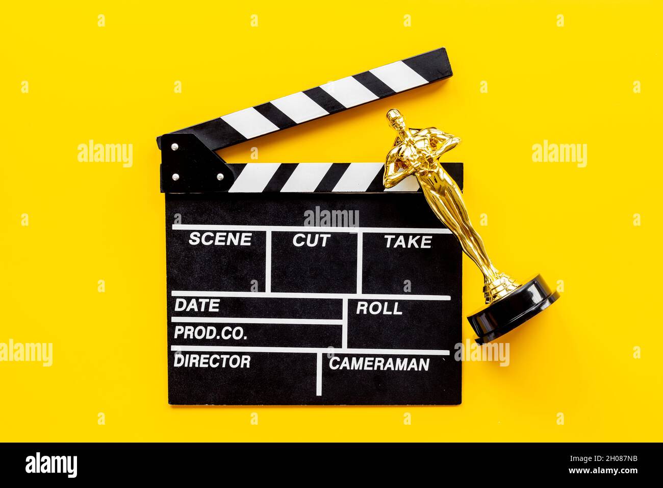 Movie clapper board with golden film award statue Stock Photo - Alamy