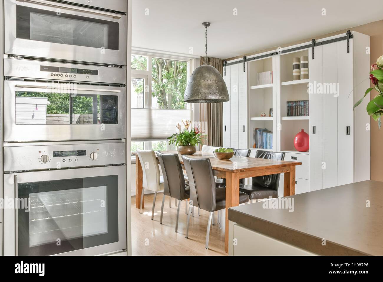 Interior shot of a dining table next to a kitchen in a nice house Stock ...