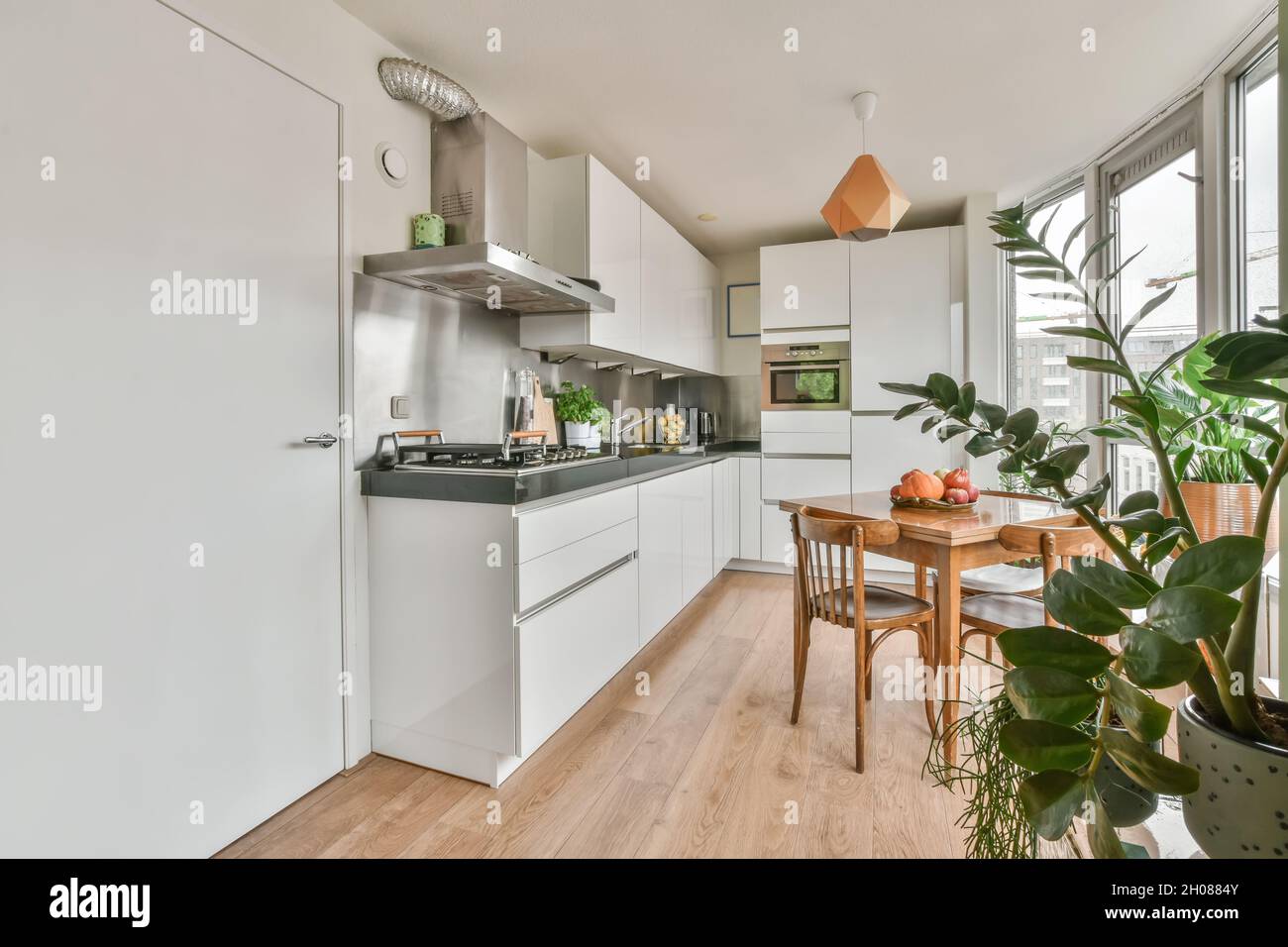 Interior shot of a dining table next to a kitchen in a nice house Stock ...