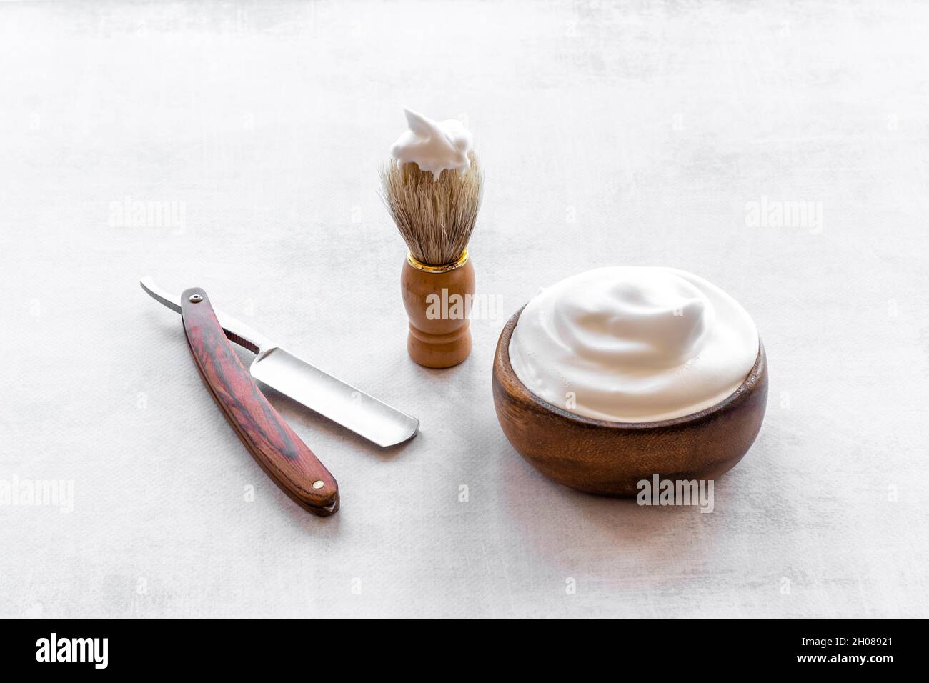 Shaving razor and foam in bowl - barber tools equipment Stock Photo - Alamy