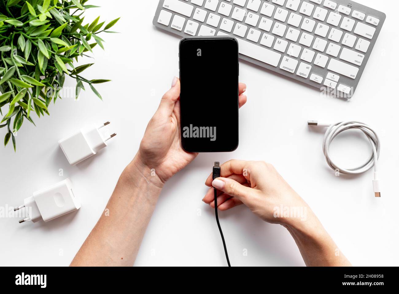 Woman hands connecting smartphone to charge cable Stock Photo - Alamy