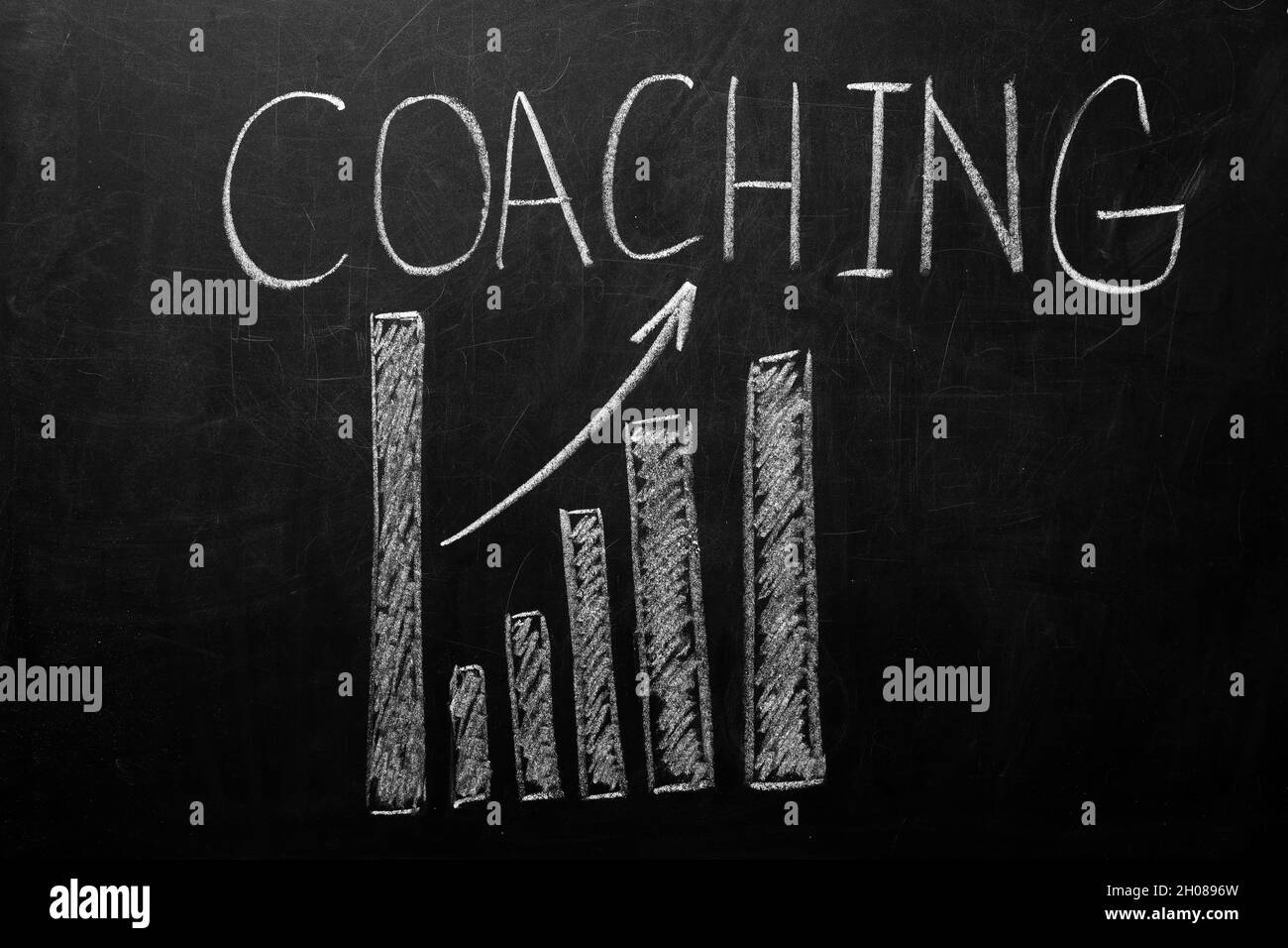 Bar chart with word COACHING on chalkboard. Business trainer concept ...
