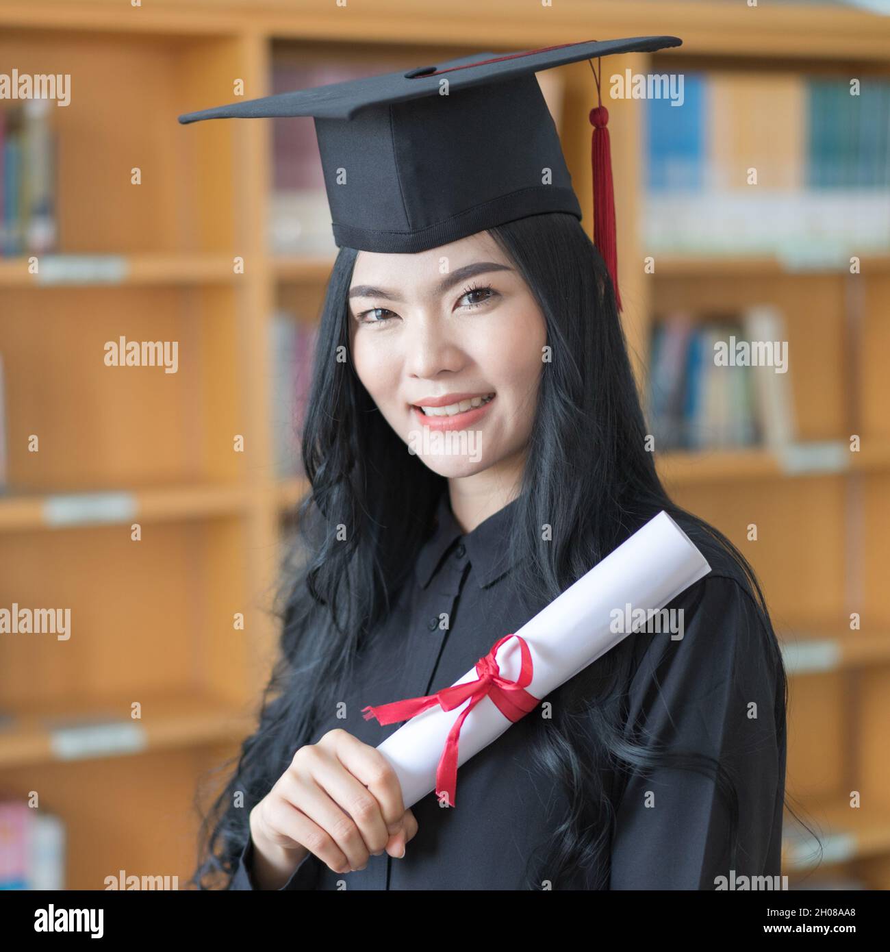 Young university graduate in a graduation gown Stock Photo - Alamy