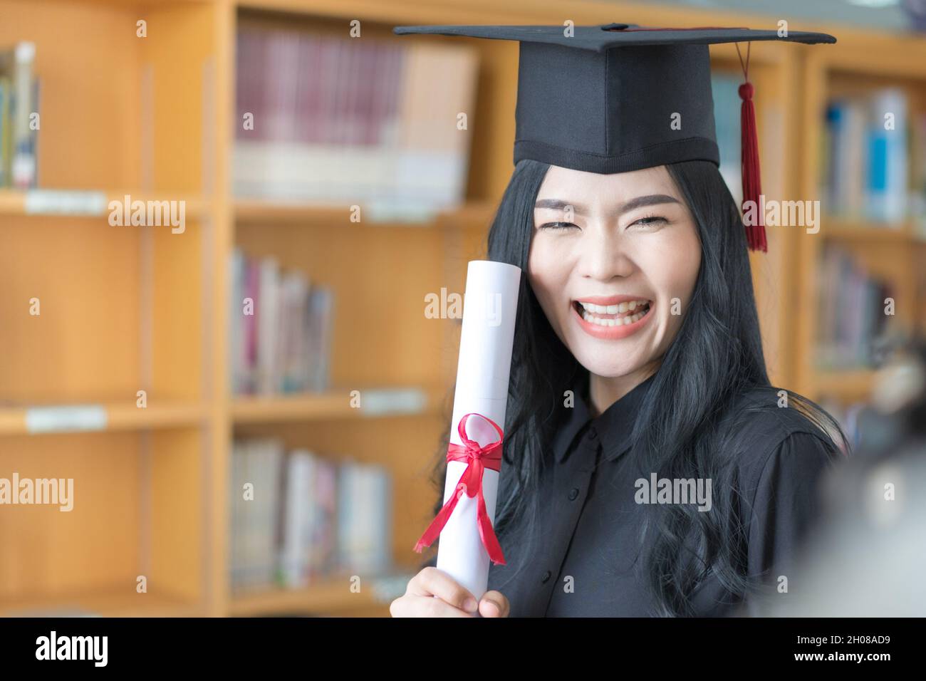 Young university graduate in a graduation gown Stock Photo - Alamy